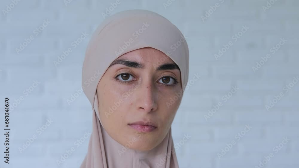 Muslim woman in hijab looks up sadly at camera. Beautiful facial ...