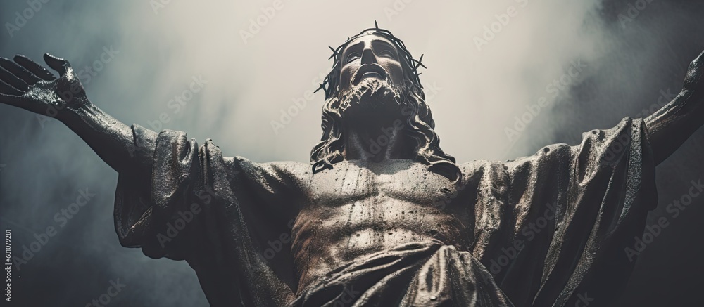 Selective focus on eyes of ancient statue of Jesus Christ with cross ...