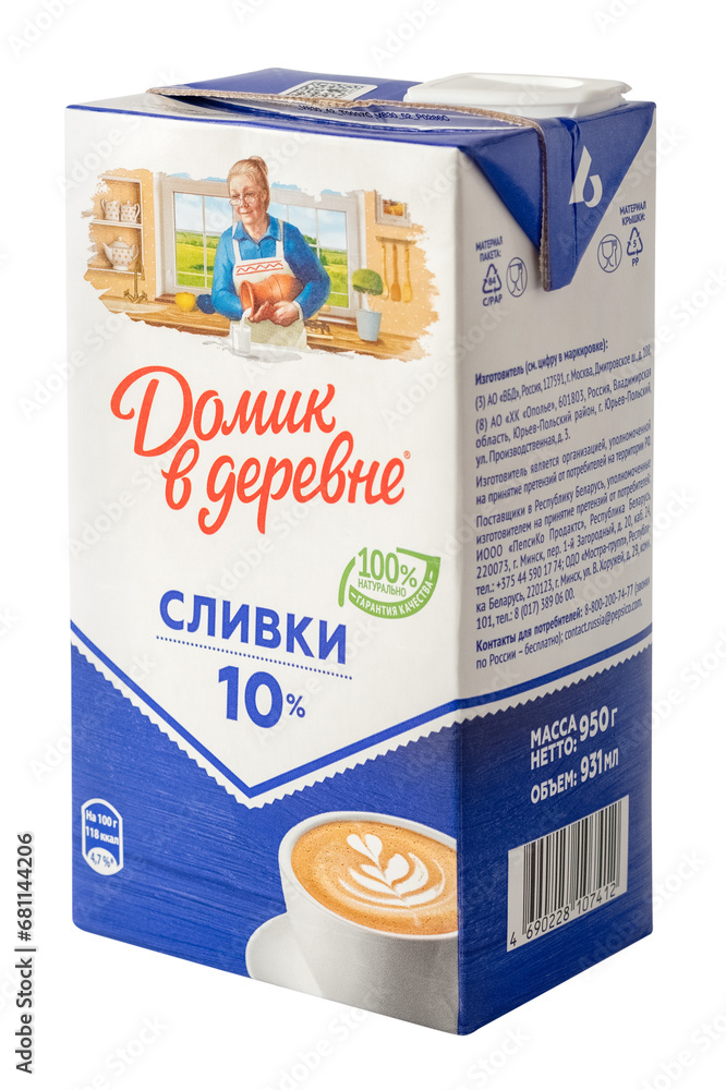 Packaging of milk cream of the “Domik v Derevne” brand on a transparent ...