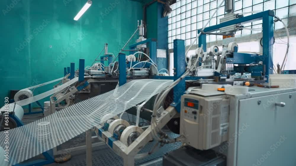 Industrial production of plastic grids. Creative. Machines winding ...