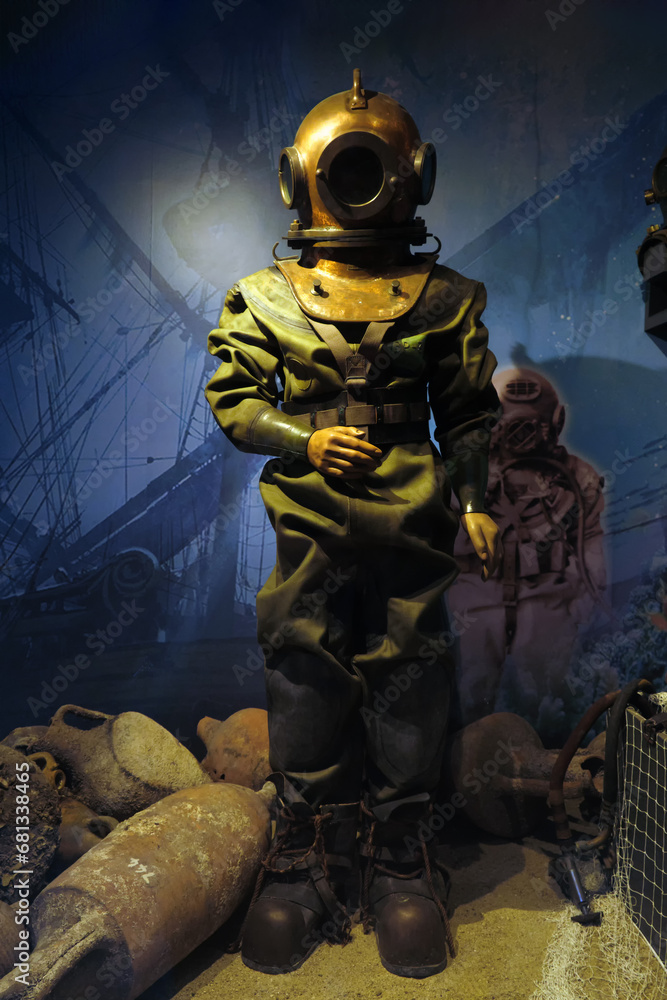 Large deep-sea diving suit with helmet and boots on a full-length ...