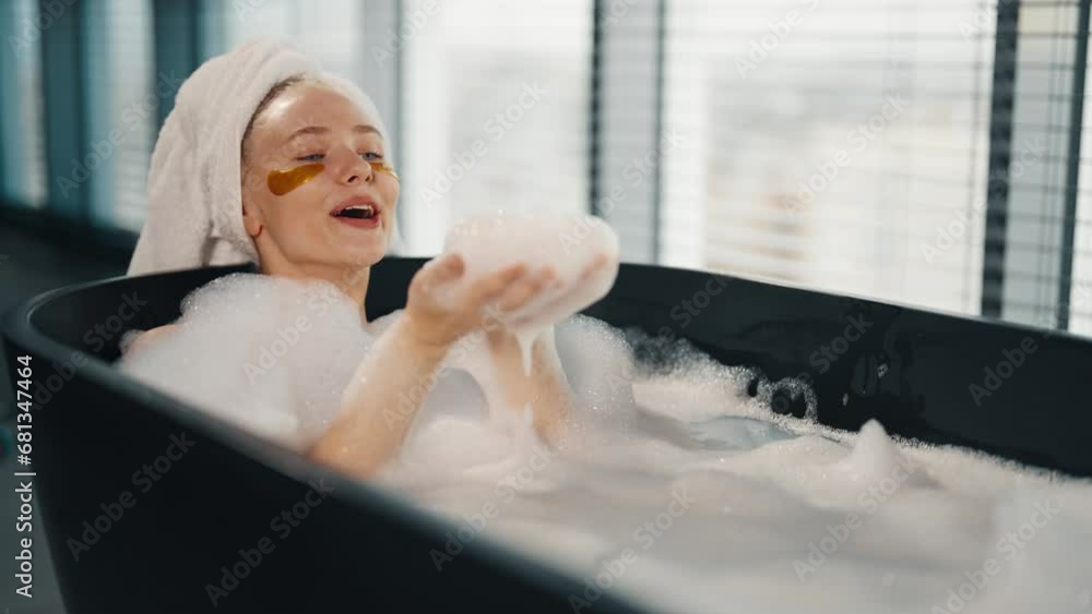 Girl enjoying taking bath with foam. Smiling positive woman with eye ...