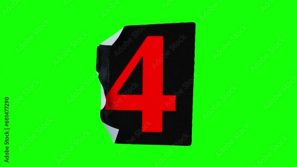 Number four printed on black piece of paper crumpling on green screen ...