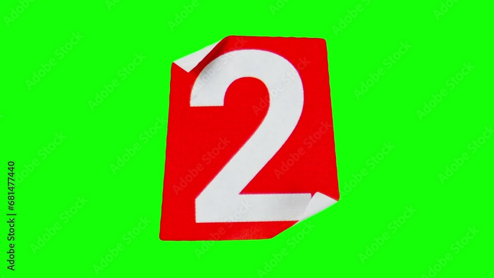 Number two on red piece of paper crumpling and unwrapping in stop ...