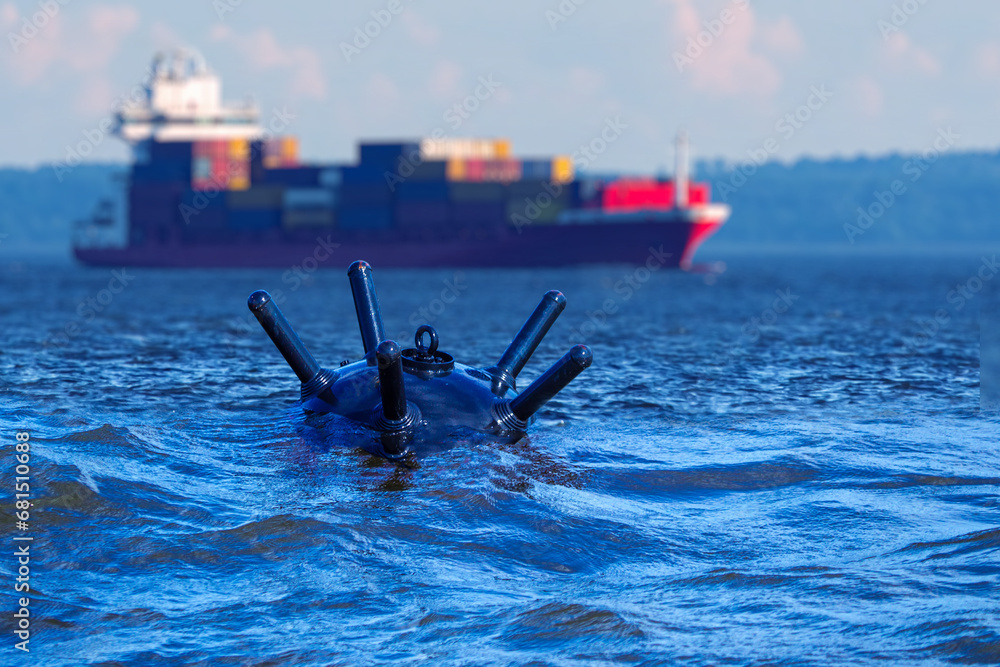 Anti-ship mine floats in water. Sea vessel approaches underwater bomb ...