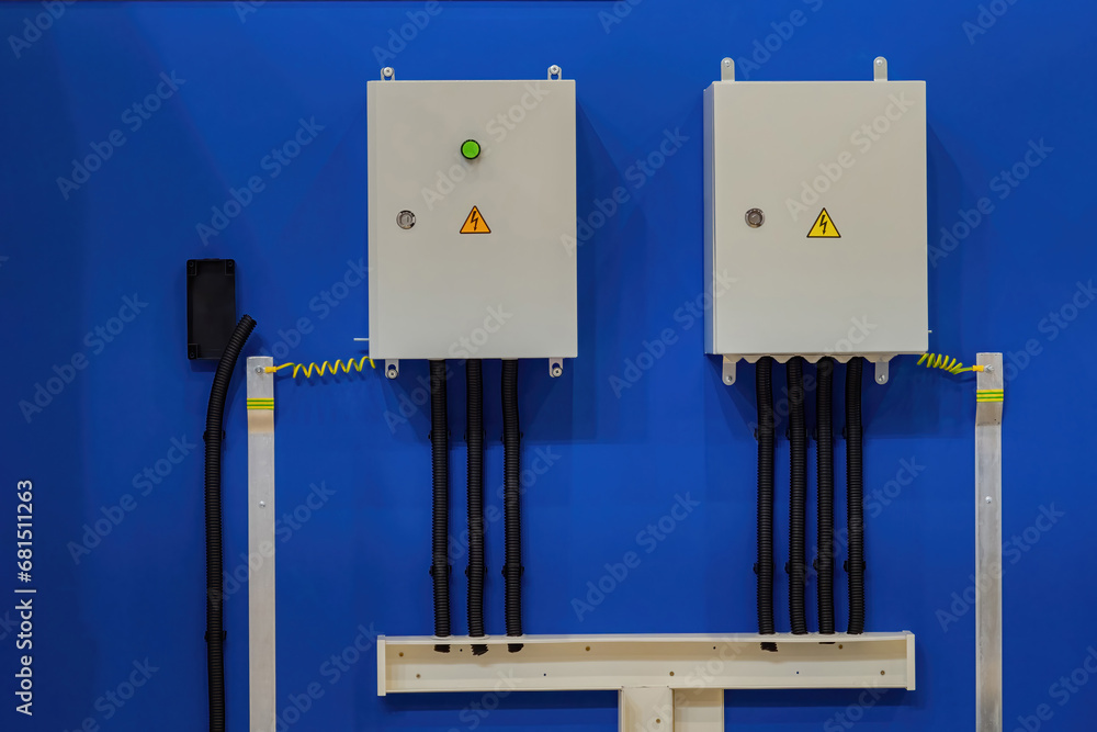 Foto de Electrical equipment. Power cabinets on blue wall. Wires are ...
