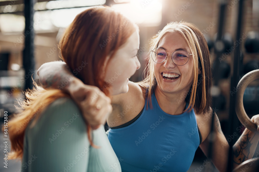 Laughing women standing arm in arm together after a gym workout Stock ...