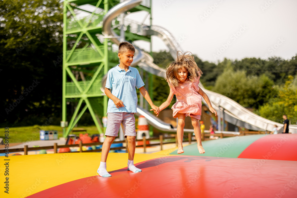 Kids jumping on inflatable trampoline, having fun visiting amusement ...