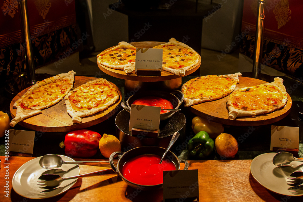 Pizza bar among catering banquet table. Variety of snacks, appetizers ...