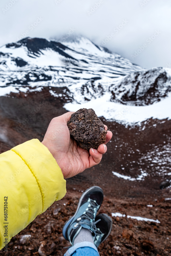 Tourist hand holding lava stone on Mount Etna crater, Sicily, Italy ...