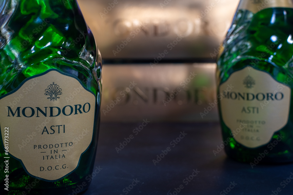 Bottles of Italian sparkling wine Mondoro Asti on blurred golden ...