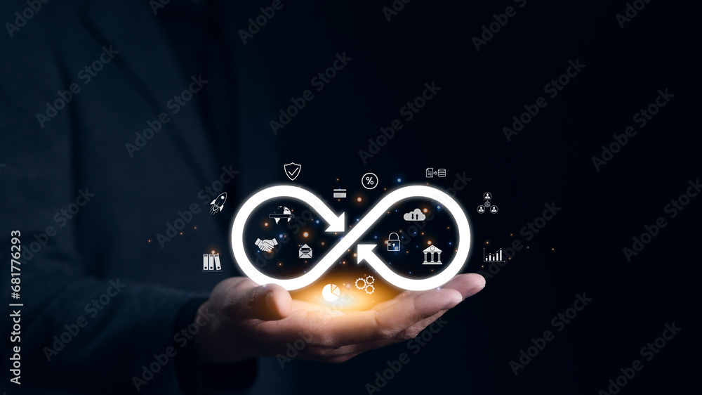 Technology data link concept. Businessman hand holding virtual infinity with business technology ...