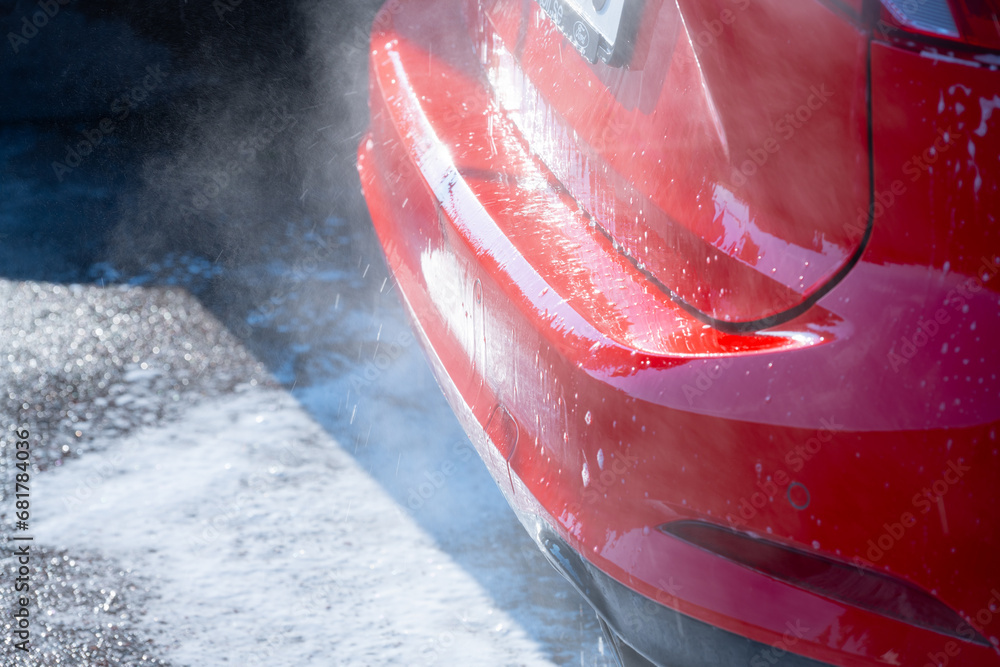Back of a red car being washed. Stock Photo | Adobe Stock