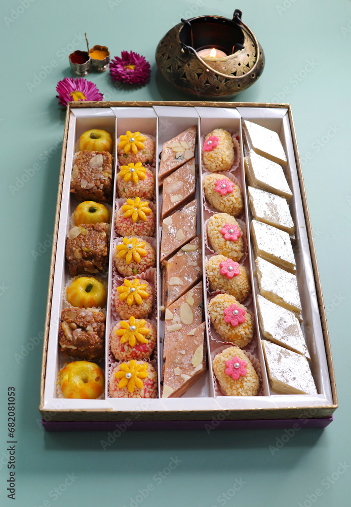 Indian assorted Diwali sweets or mithai box with diya and flowers ...