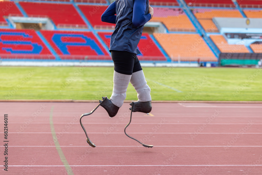 Asian para-athlete with prosthetic blades leg in stadium practicing ...