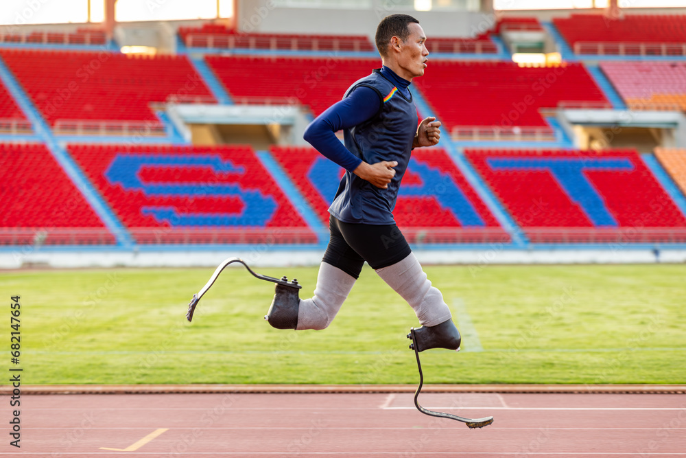 Asian para-athlete with prosthetic blades leg in stadium practicing ...