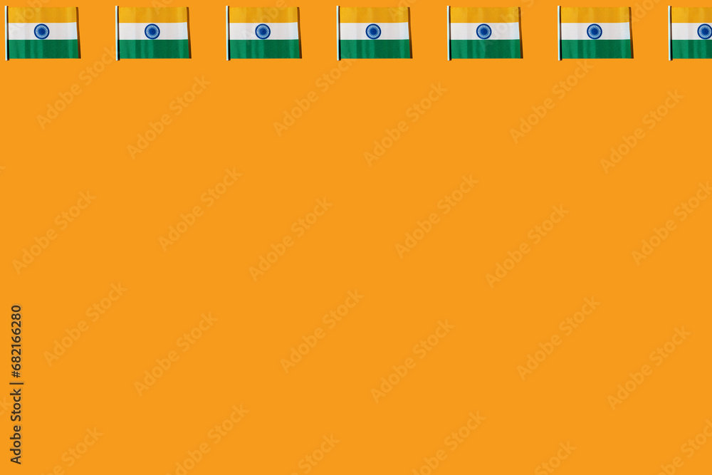 Pattern of flags of the Republic of India, on top, on orange background ...