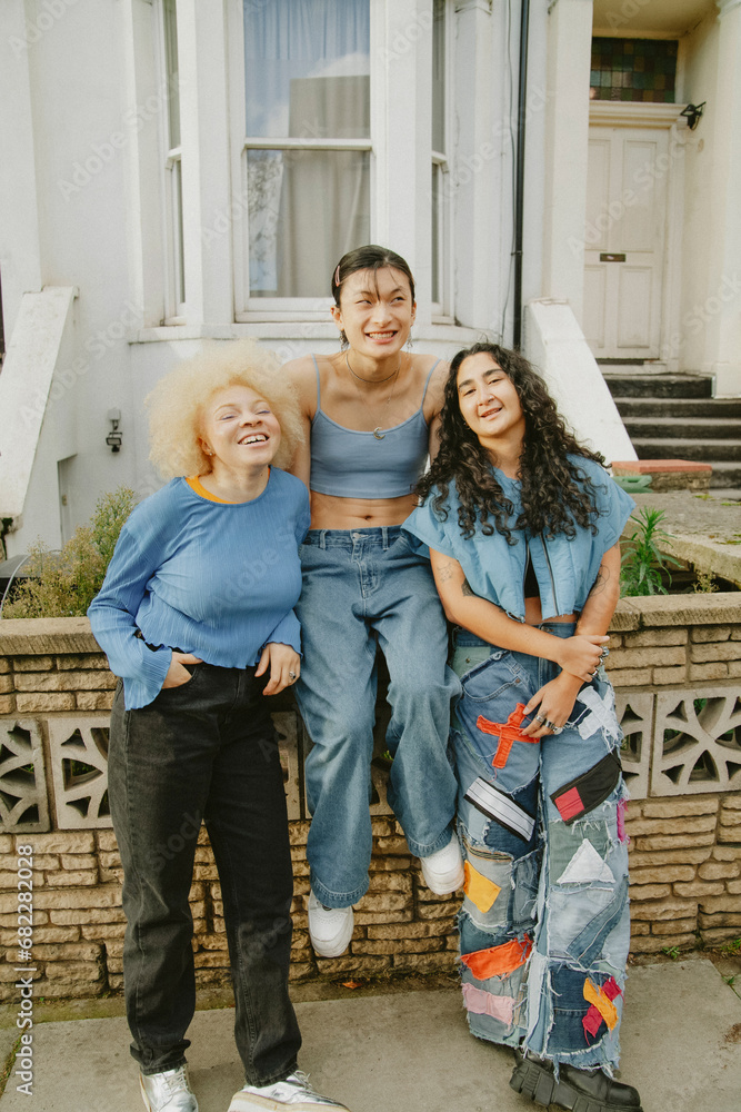 Happy group of multiracial friends in blue outfits posing outdoors ...