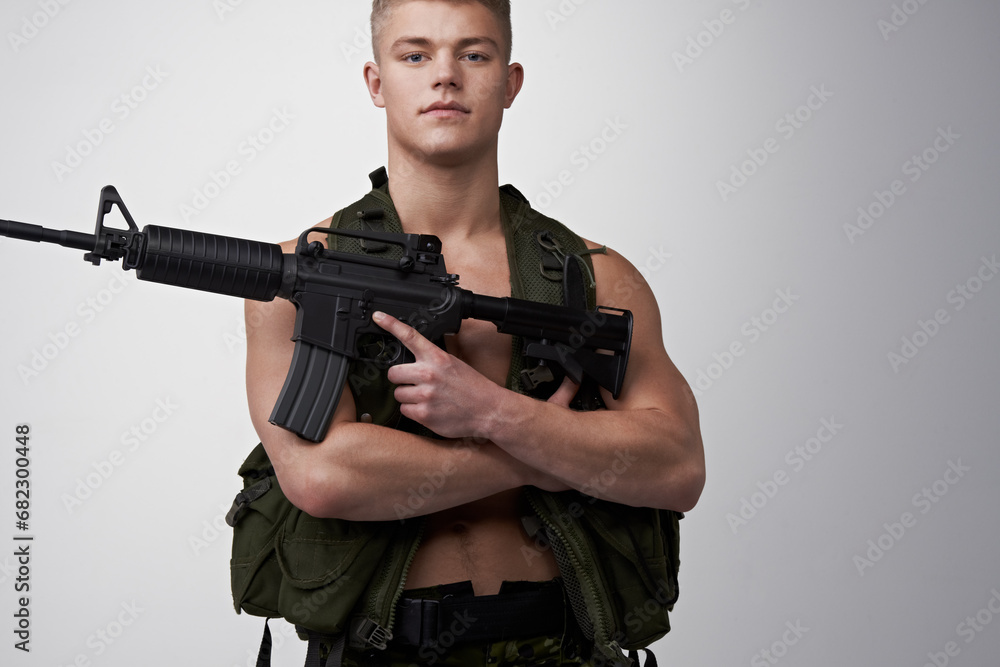 Soldier man, vest and rifle in studio portrait for military service ...