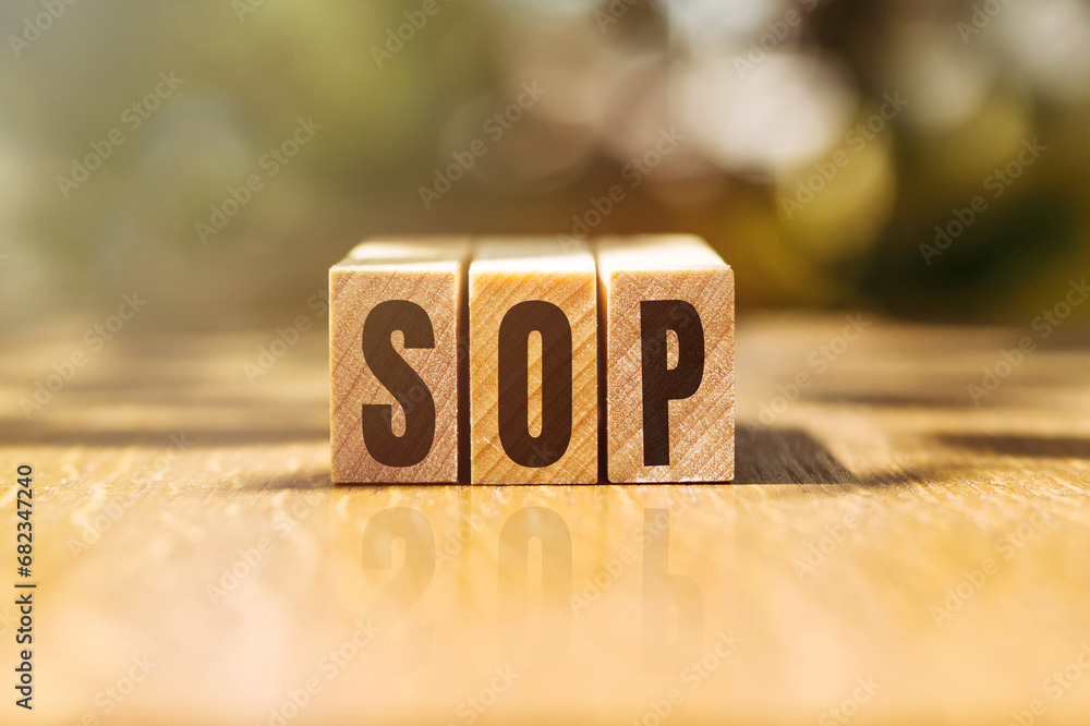 SOP - acronym from wooden blocks with letters, abbreviation SOP ...