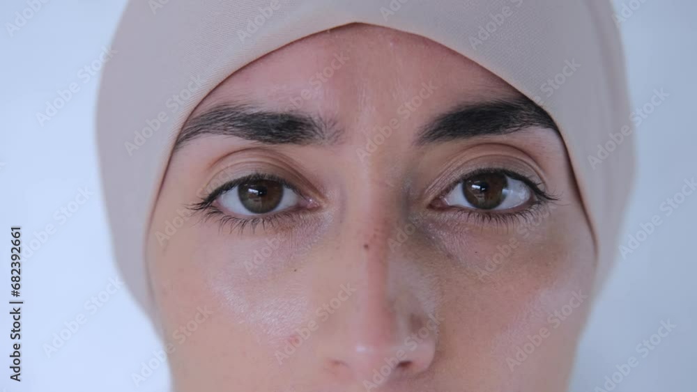 Vidéo Stock Closeup of large beautiful brown eyes of Muslim woman ...