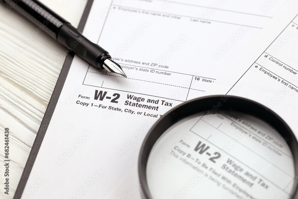 IRS Form W-2 Wage and Tax Statement blank on A4 tablet lies on office ...