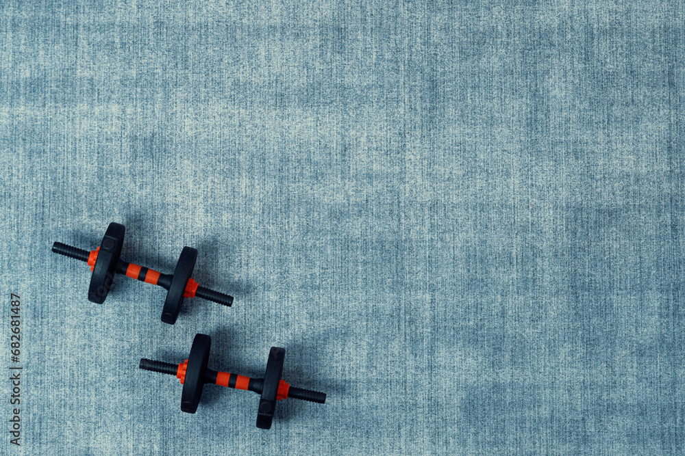 Fitness and bodybuilding concept with top view dumbbell laying on grey ...