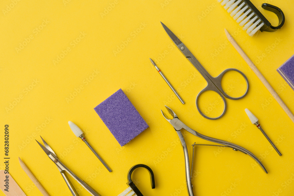 Professional manicure tools on yellow background. Manicure set. Top ...