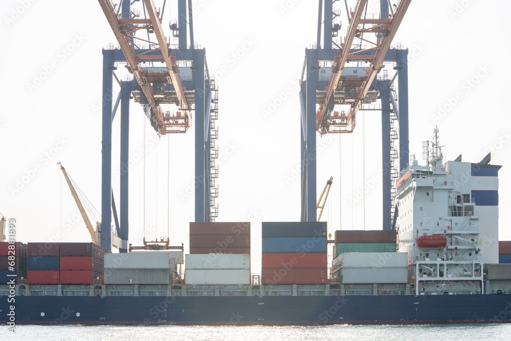 Big crane loading cargo container from truck to container ship in the ...