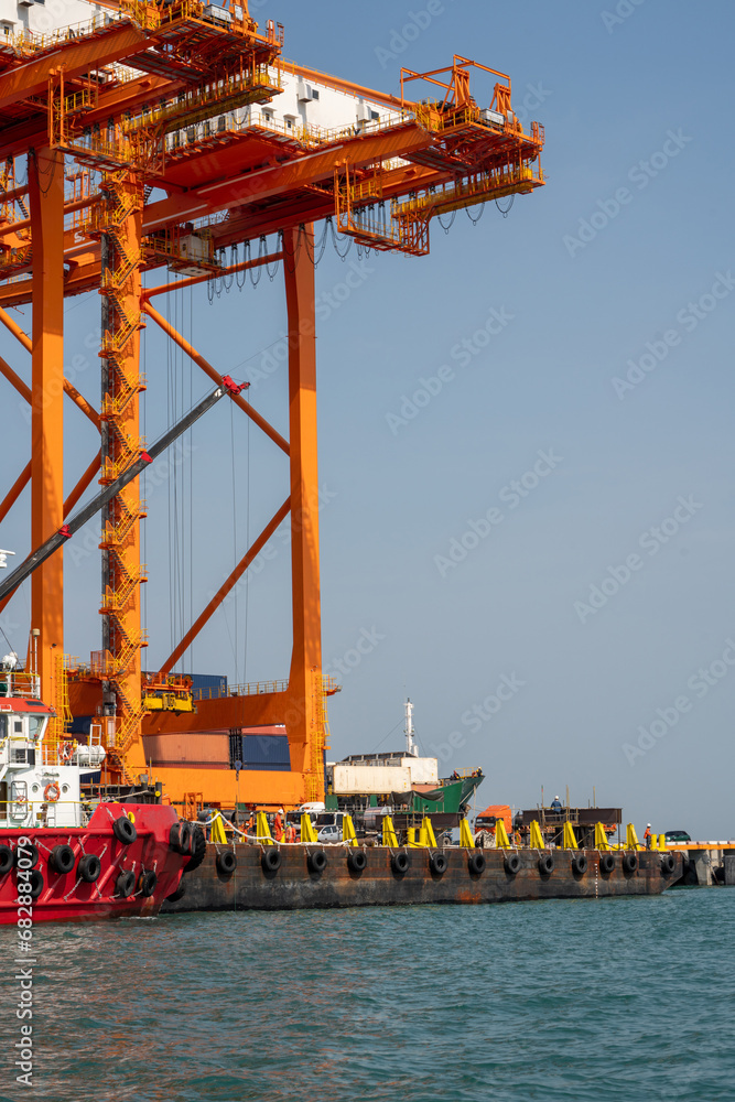 crane loading cargo container from truck to container ship in the ...