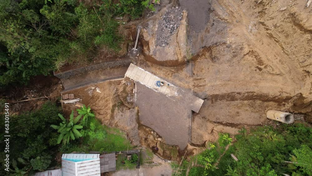 Top-down aerial view of construction site at location of road damaged ...