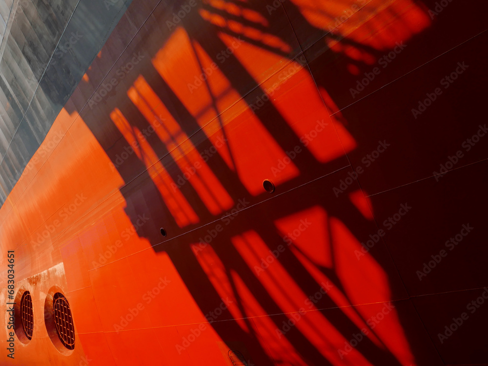 shadow of a crane on ship's hull. ship in drydock out of water. Stock ...