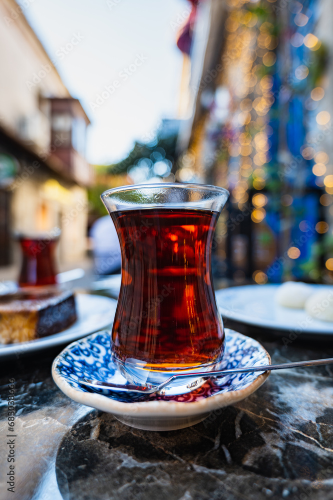 Turkish Tea in traditional tea glass and saucer in Turkey, street ...