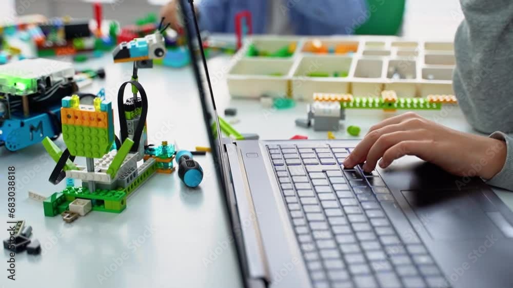 School Children construct and code Robot. STEM education using laptop ...