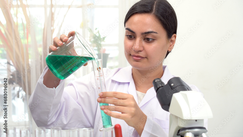 Researcher asian woman wear lab cost work mixing test tube specialist ...
