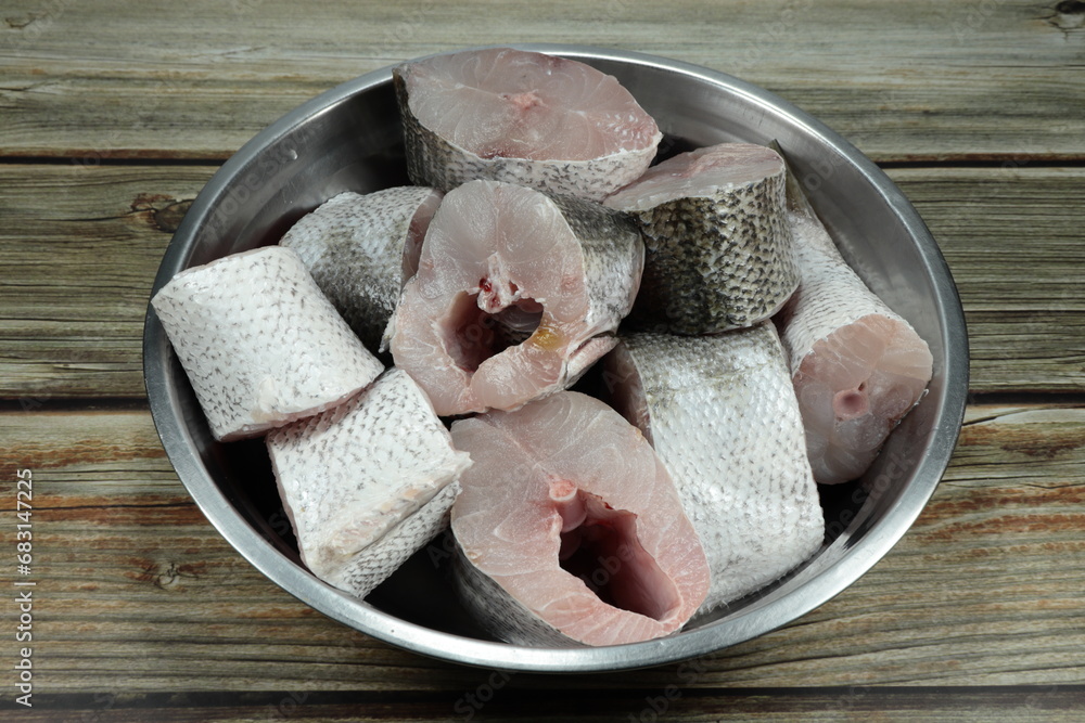 Pile of fresh and organic sliced barracuda fish fillet in the tray ...