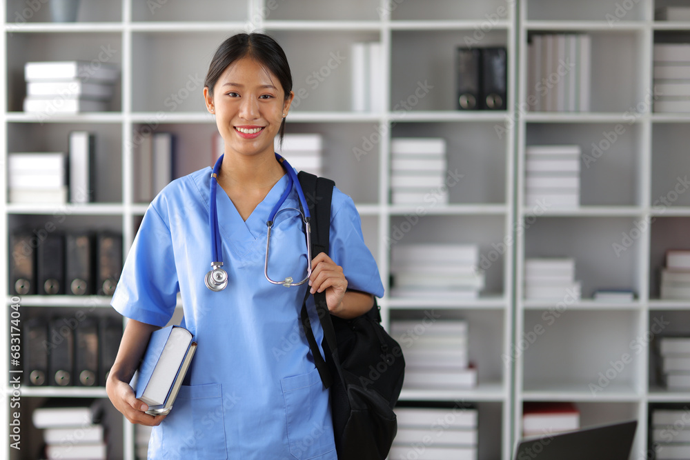 Internship medical students carry bags and textbooks in the library ...