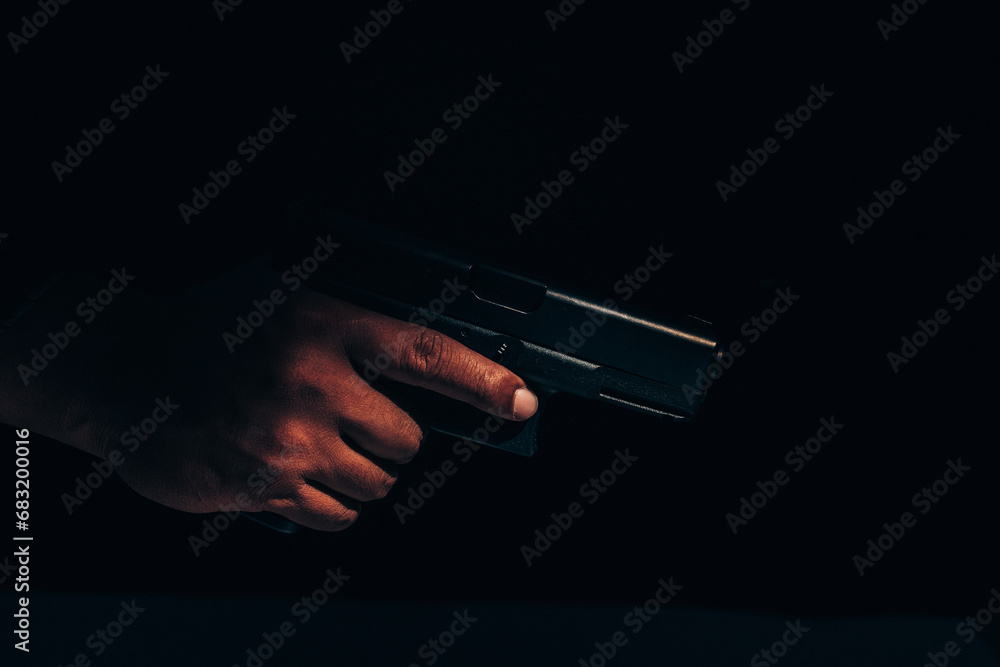 Close-up of a man's hand holding a small pistol ready to shoot in the ...