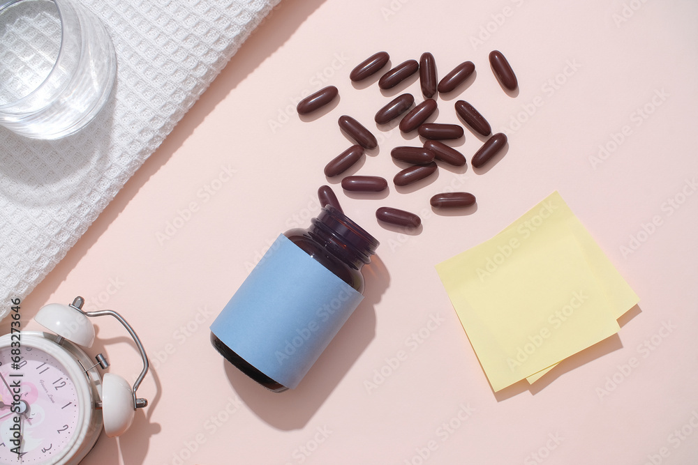 Brown capsules are poured onto the table from an unlabeled pill bottle ...