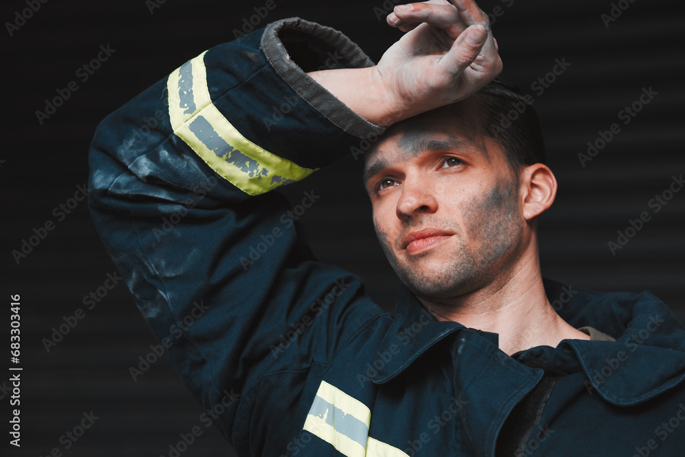 Firefighter, tired and man thinking of job on a black background with ...