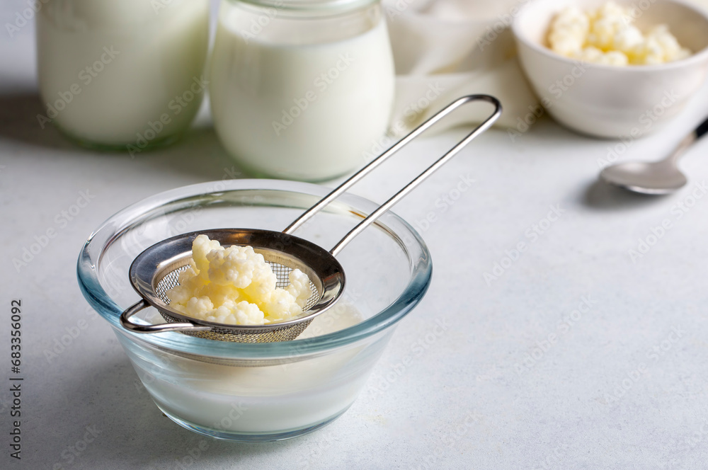 Kefir fermented milk drink with kefir grains. Homemade kefir stands in ...