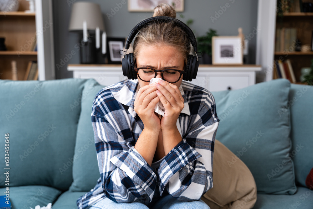 Sad tired young woman touching forehead having headache migraine or ...