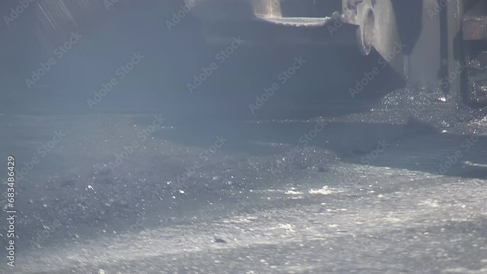 Dispersing poured tar on a road with a rake Stock Video | Adobe Stock