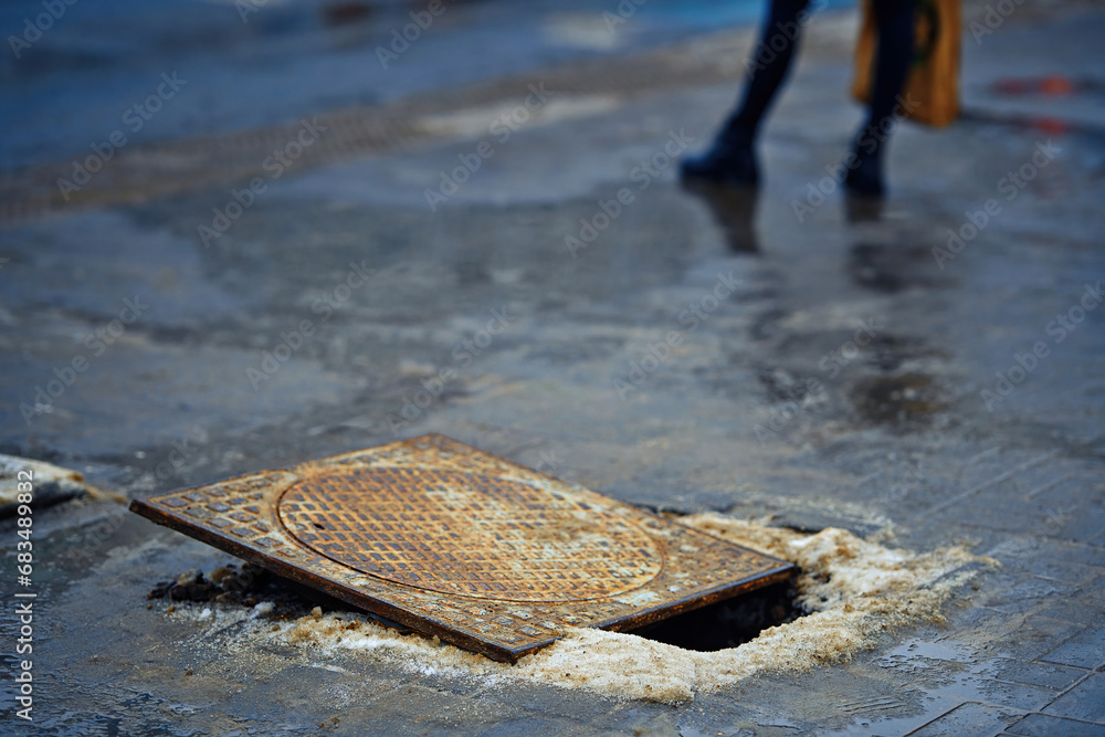 Hole on footpath. Broken manhole, pothole in paving slabs, damaged ...