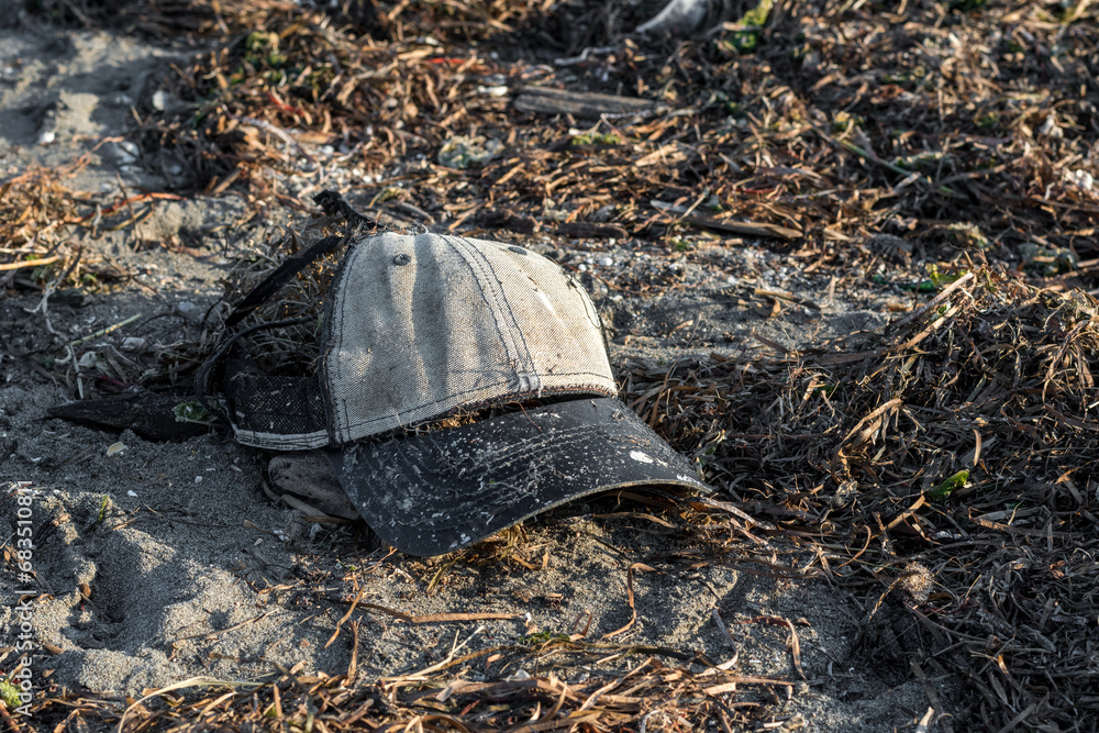 Beach in northern Italy after a violent storm. Cap, Hat, Plastic and ...