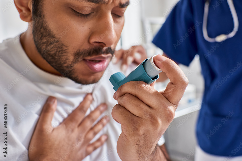 african american nurse helping her indian patient with asthma inhaler ...
