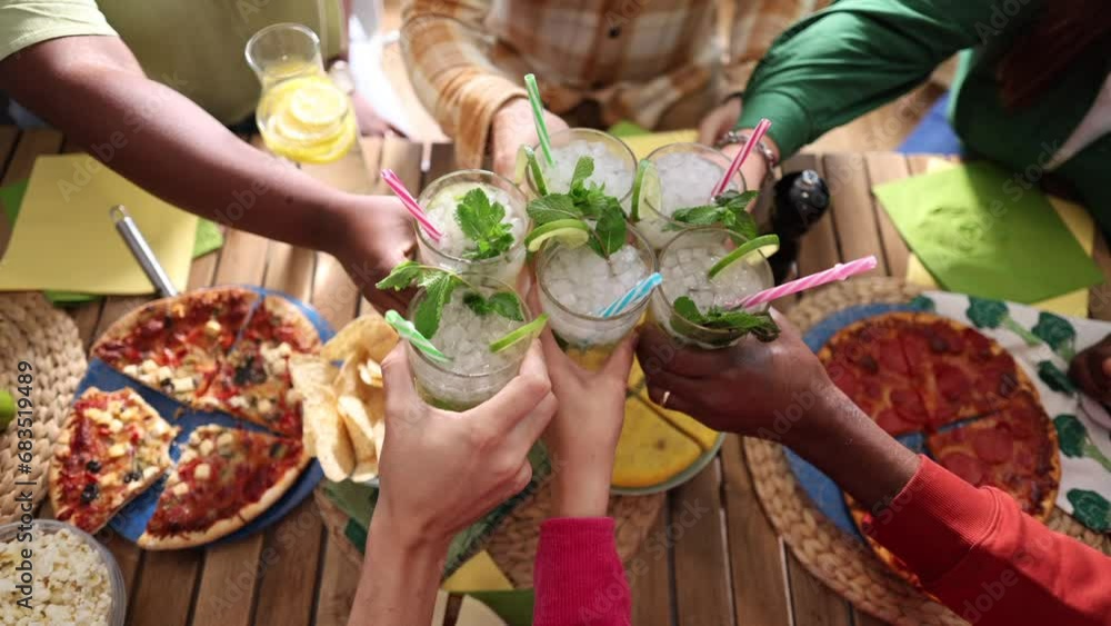 Friends celebrating a meal while toasting with cocktails. Group of ...