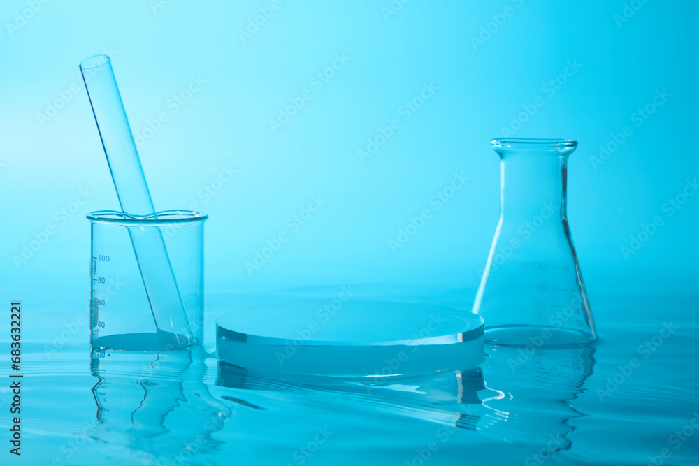 Some laboratory glassware displayed with a round shaped podium. Glamor ...