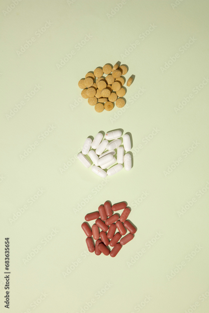 Three types of tablets with three colors of red, white, yellow are ...
