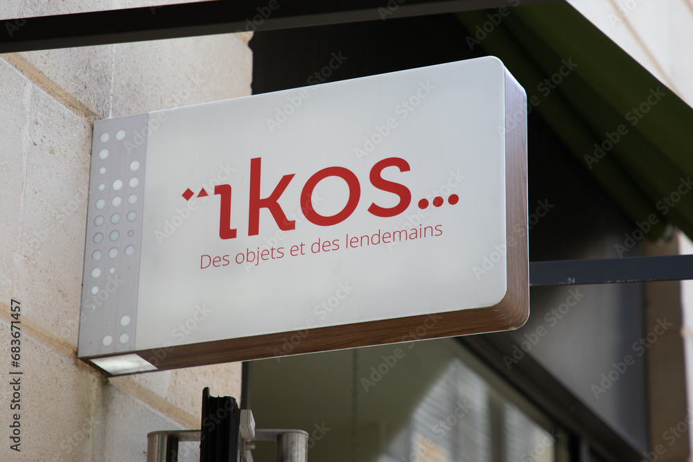 ikos second-hand and recycling store logo text and brand sign on facade ...